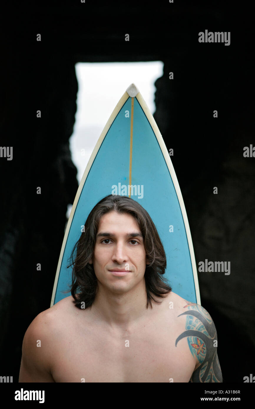 View of a young man with a surfboard Stock Photo - Alamy