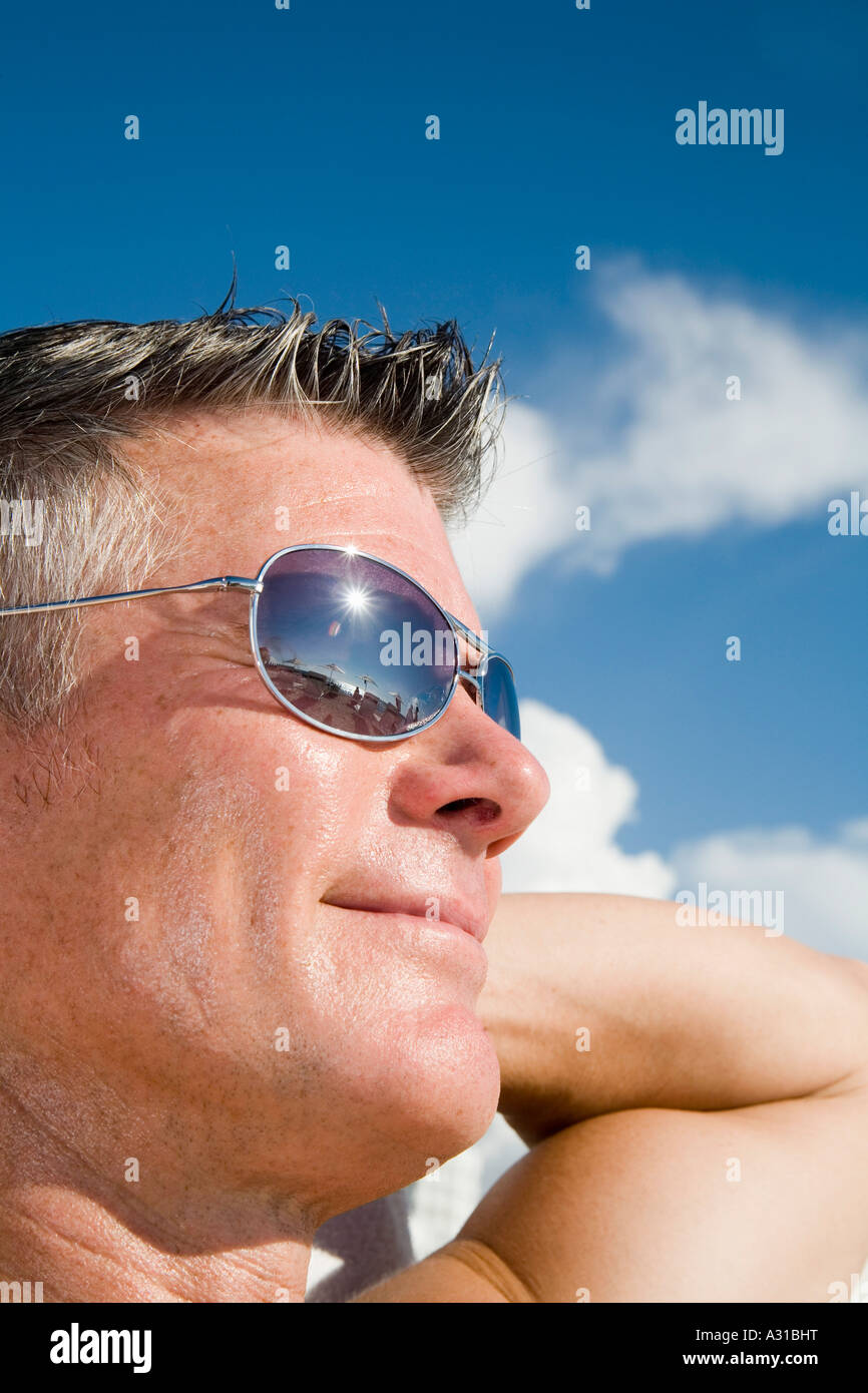 Man sunbathing and wearing sunglasses Stock Photo - Alamy