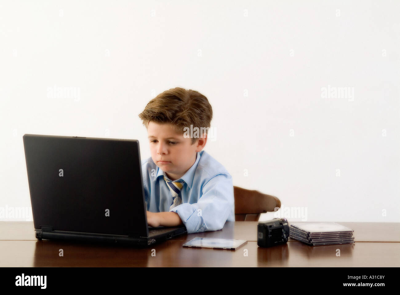 Boy working with laptop Stock Photo - Alamy