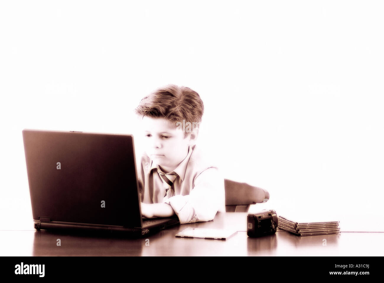 Boy working with laptop Stock Photo - Alamy