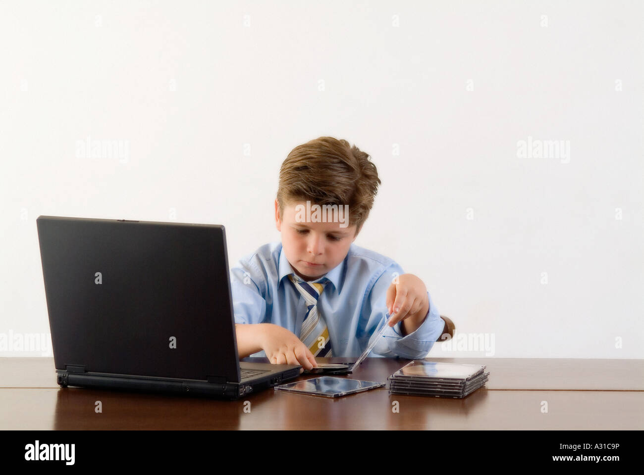 Boy working with laptop Stock Photo - Alamy