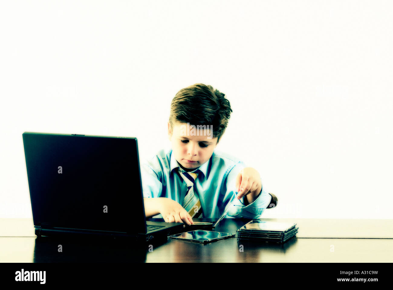Boy working with laptop Stock Photo - Alamy