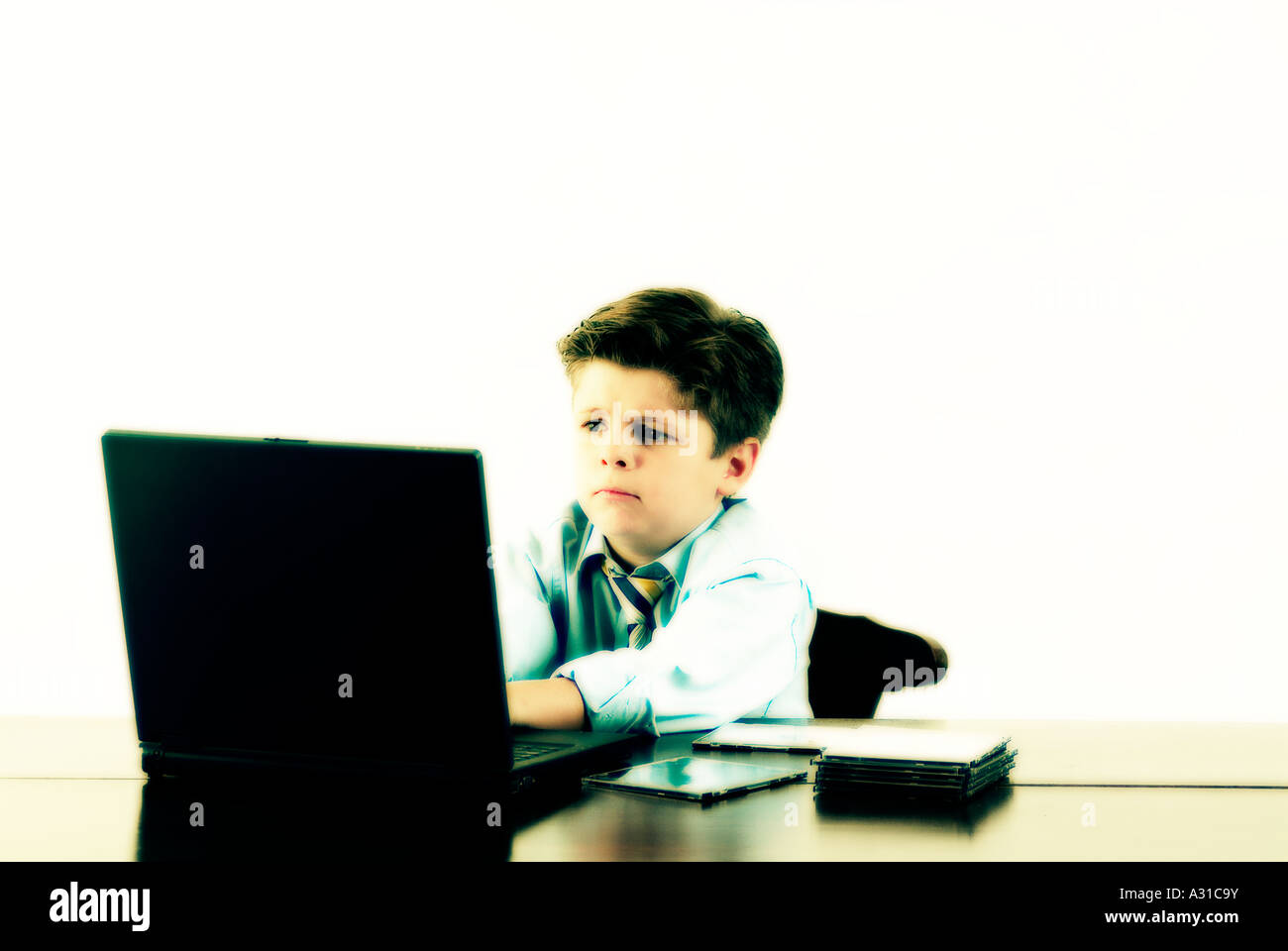 Boy working with laptop Stock Photo - Alamy