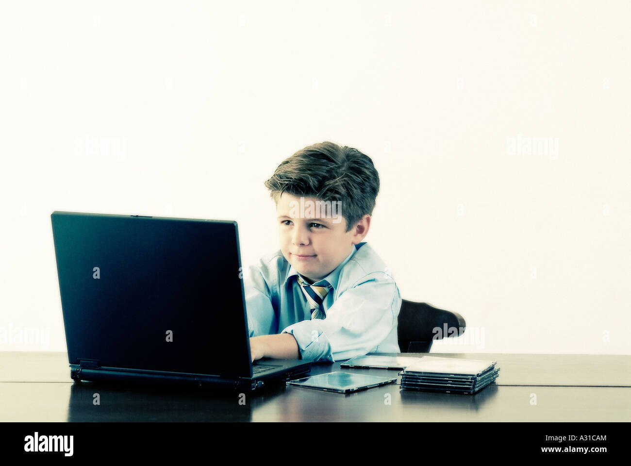 Boy working with laptop Stock Photo - Alamy