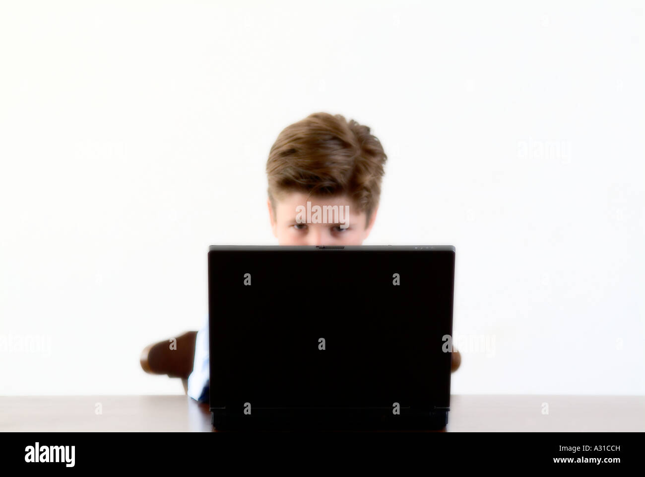 Boy working with laptop Stock Photo - Alamy