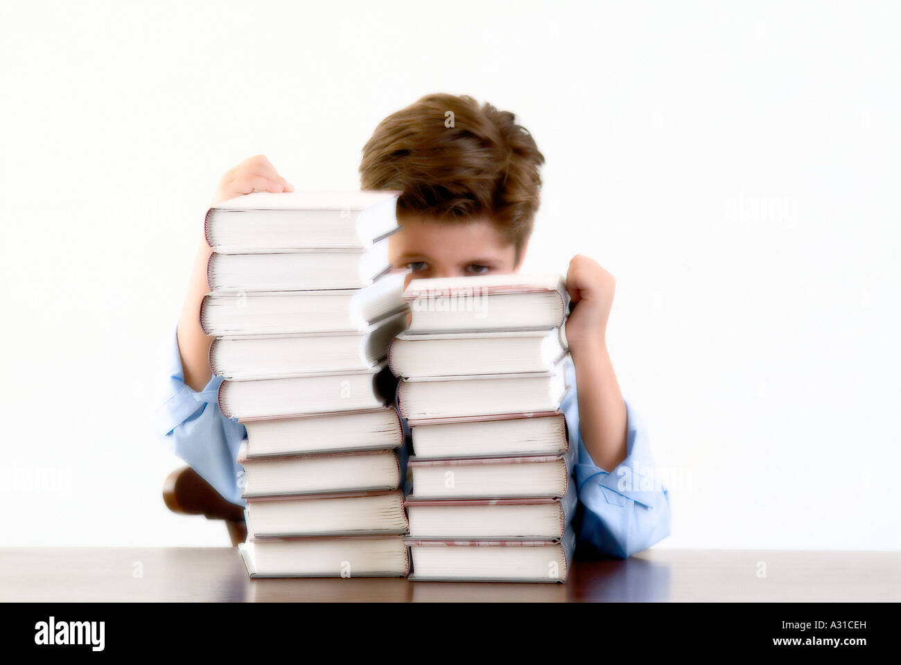 Child with piles of books Stock Photo - Alamy