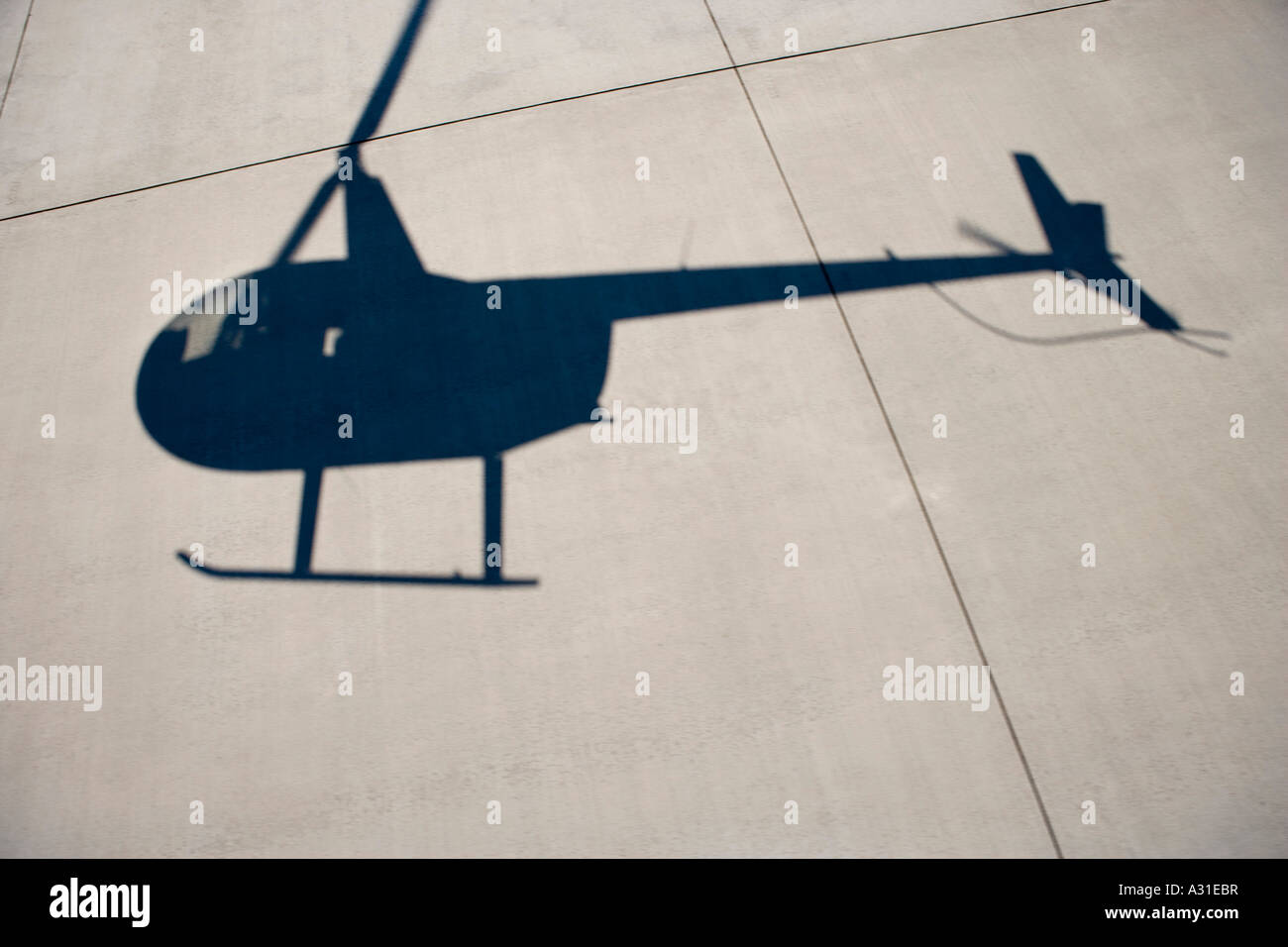 Shadow of a helicopter on airport tarmac Stock Photo - Alamy