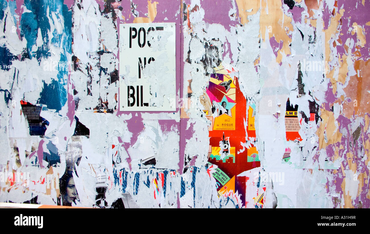 Post No Bills sign pasted over peeled posters creating abstract ...