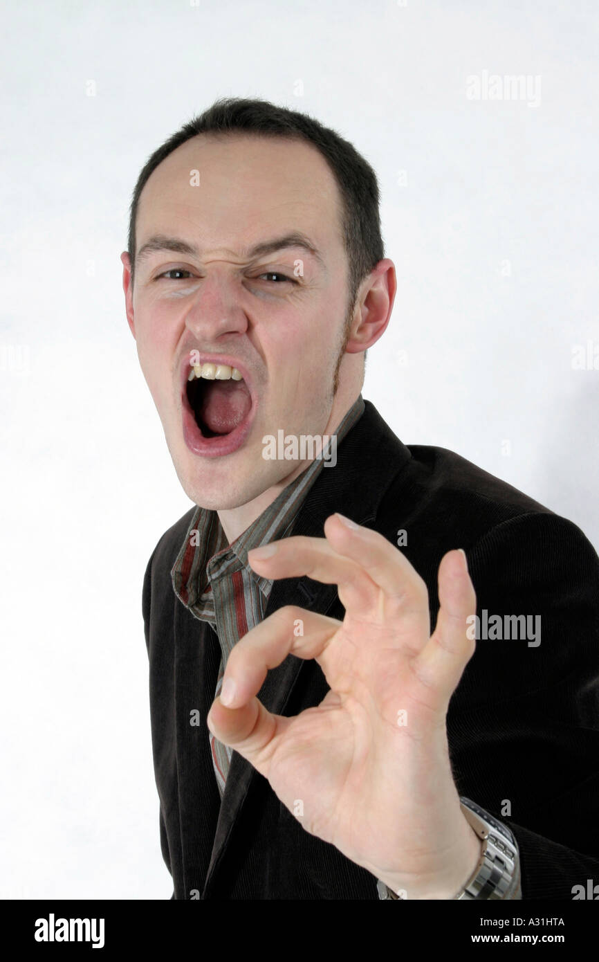 Young man giving hand signal close up portrait Stock Photo - Alamy