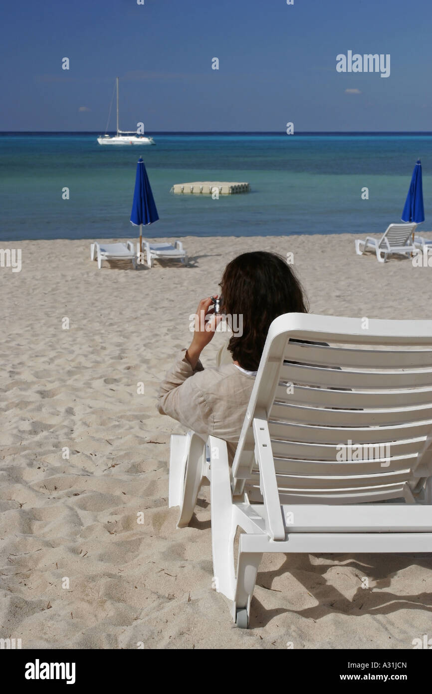 Woman using mobile phone on beach cozumel hi-res stock photography and images - Alamy