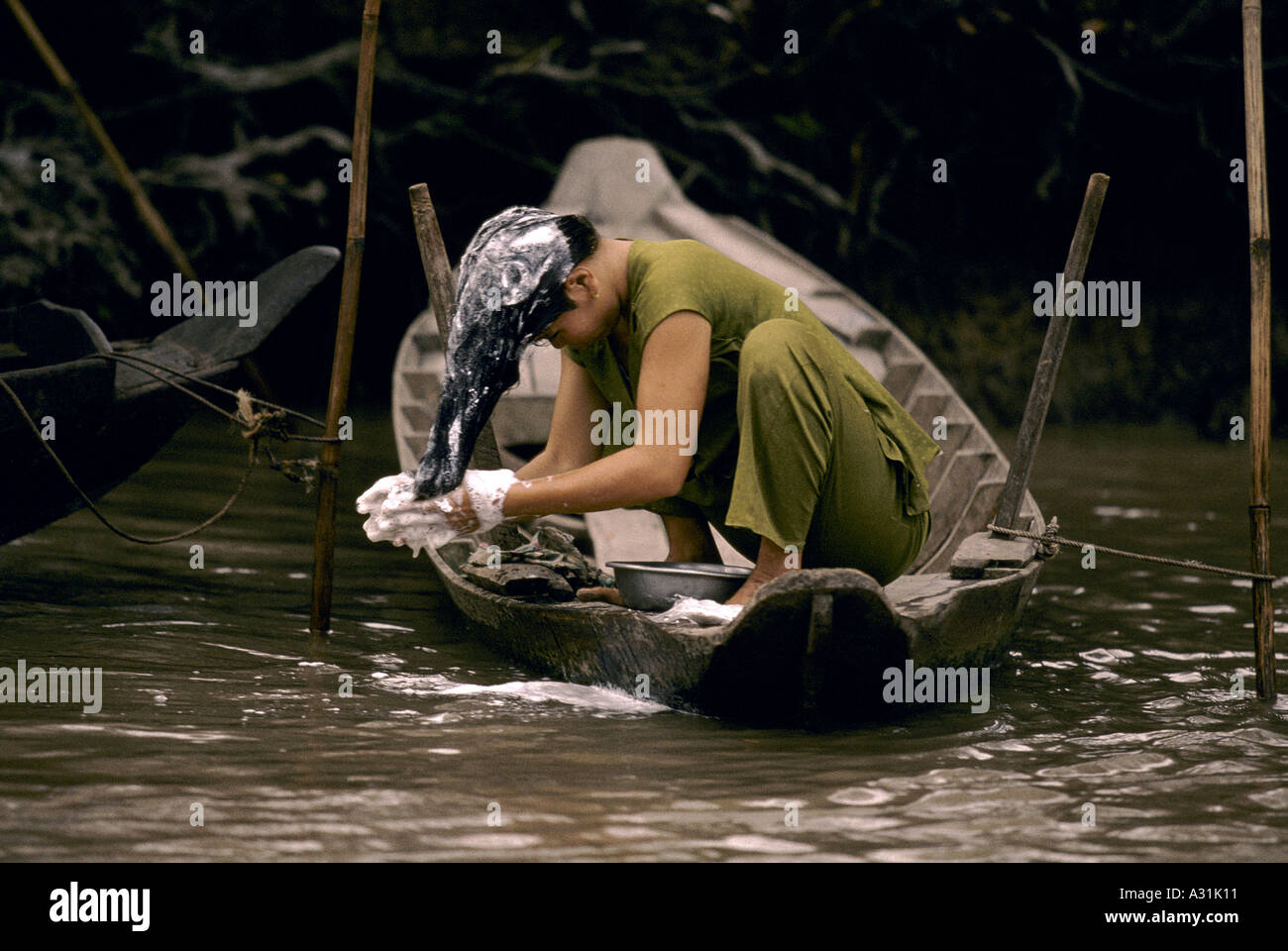 mekong delta vietnam woman washing her hair in the mekong delta vietnam ...