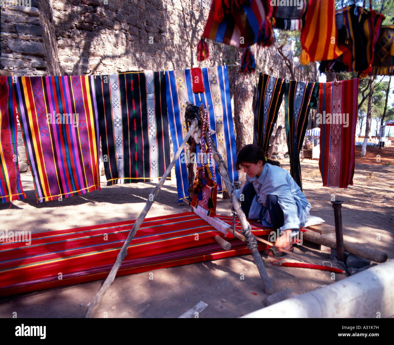 Woman weaving a turkish carpet in the city of Izmir, Turkey Stock Photo ...