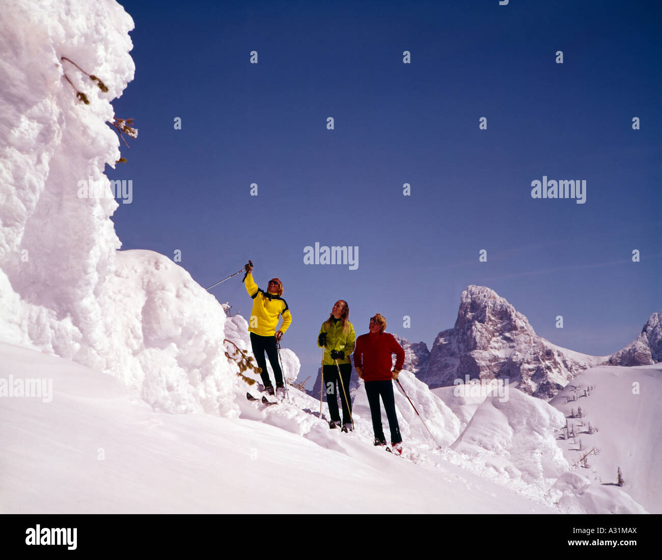 Three skiers stop to enjoy their spectacular surroundings at Grand ...