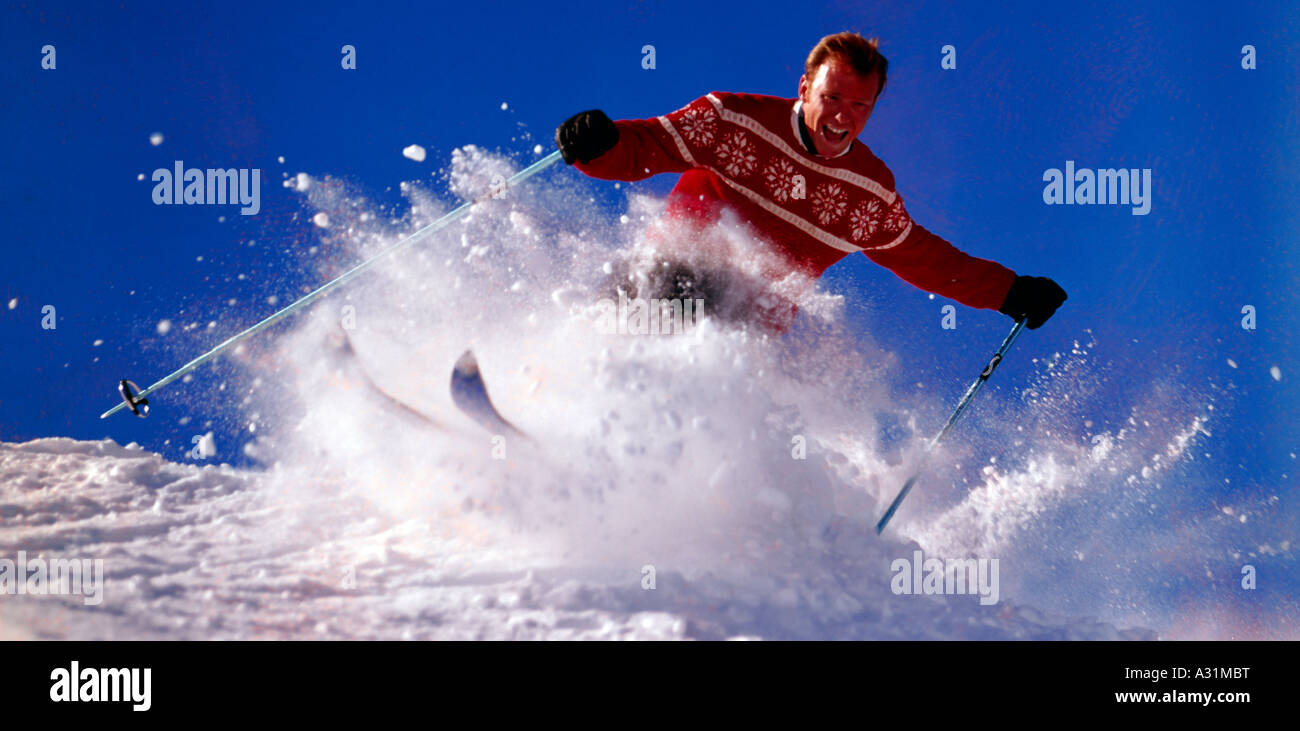 Wide field view of dramatic ski action as a youthful athlete bursts ...