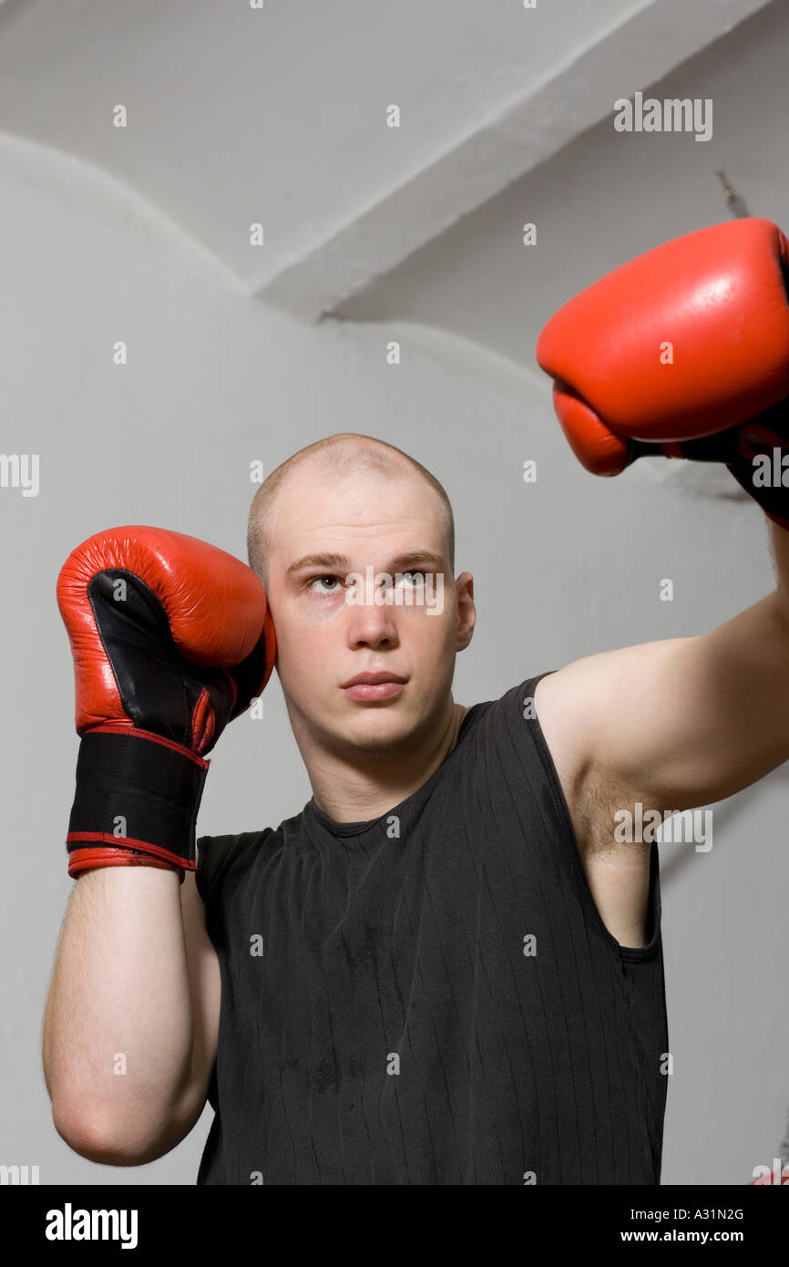 Young male boxer standing with fists raised Stock Photo - Alamy