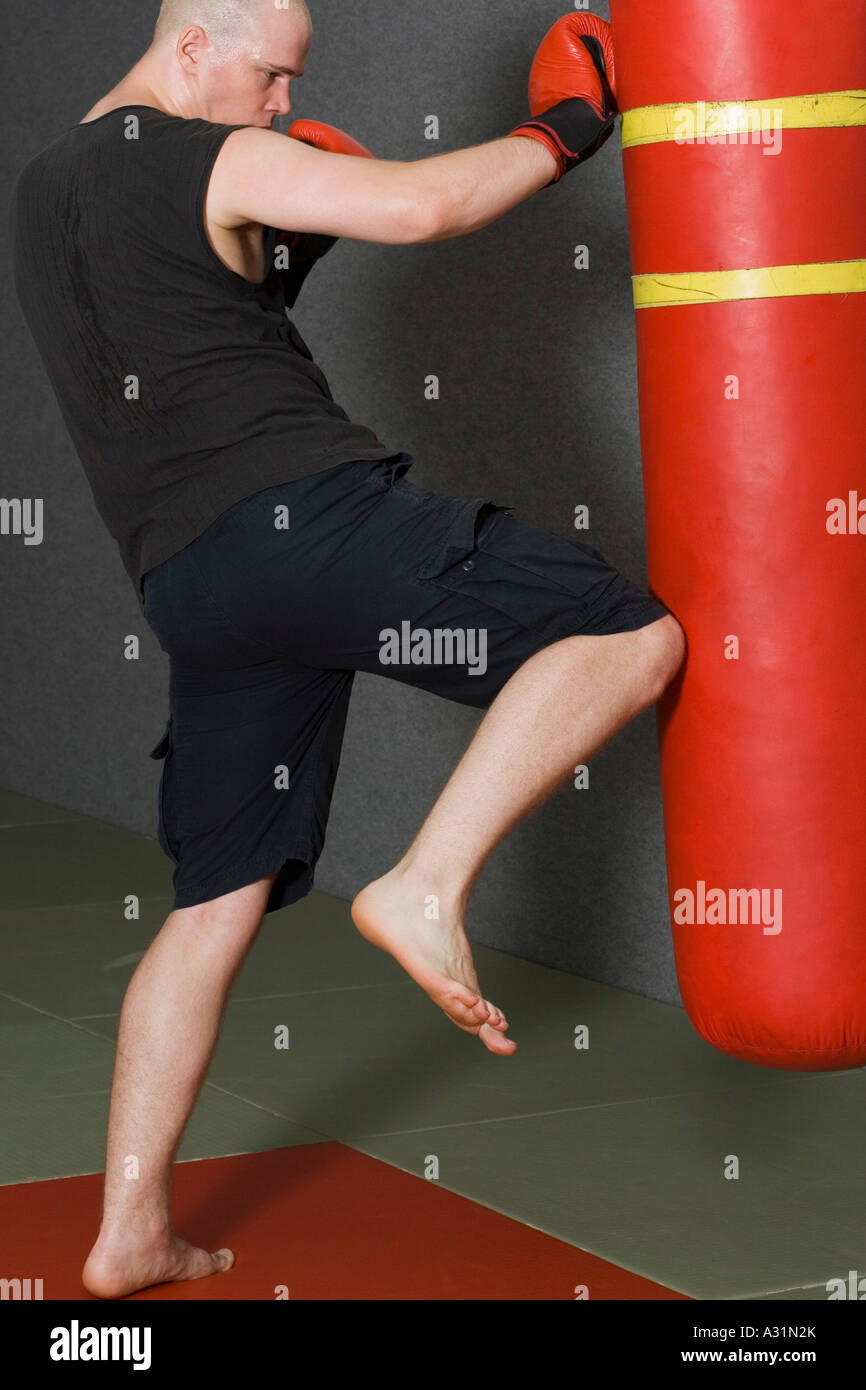 Young man kickboxing in gym Stock Photo - Alamy