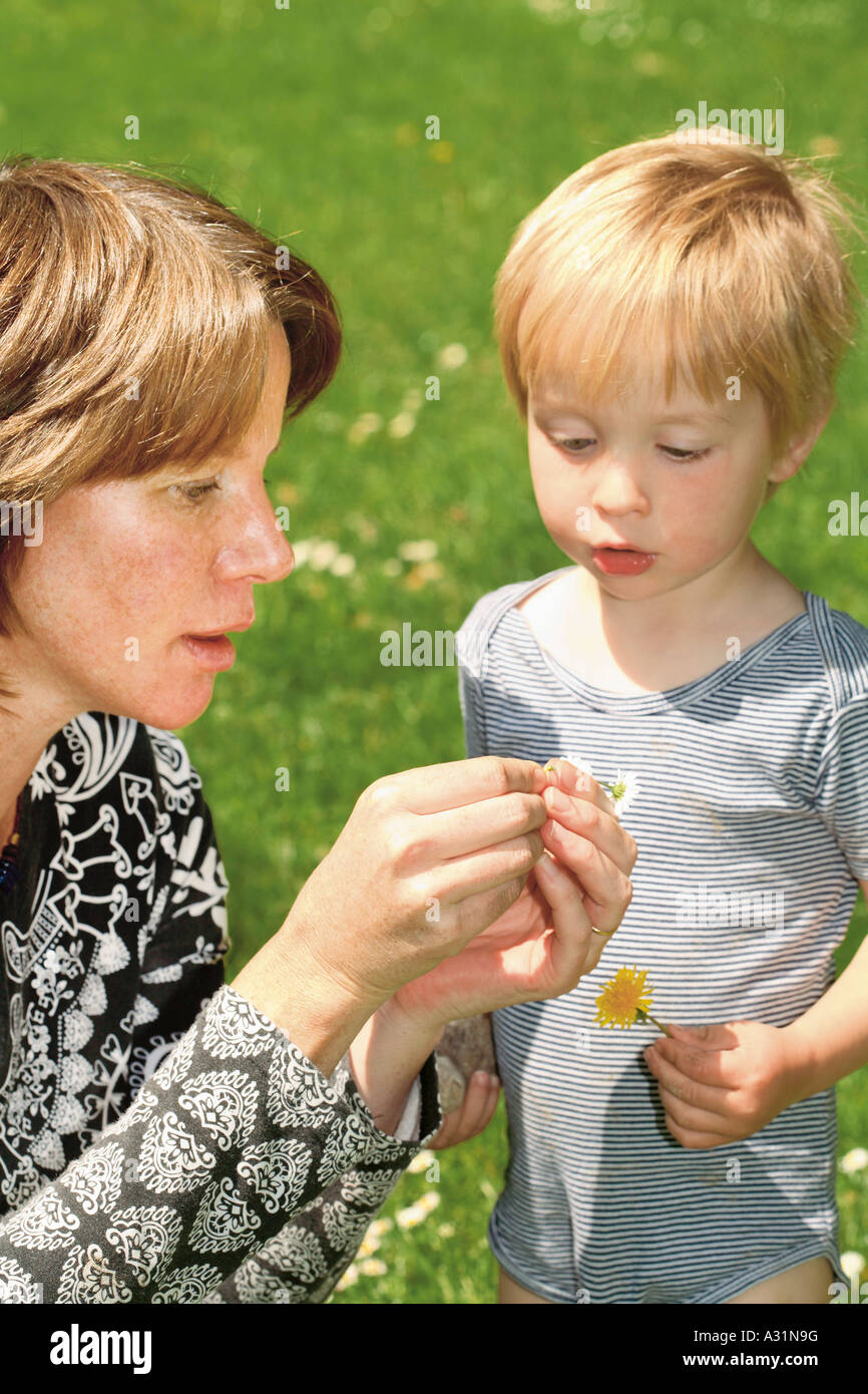 Mother and son making daisy chain Stock Photo - Alamy