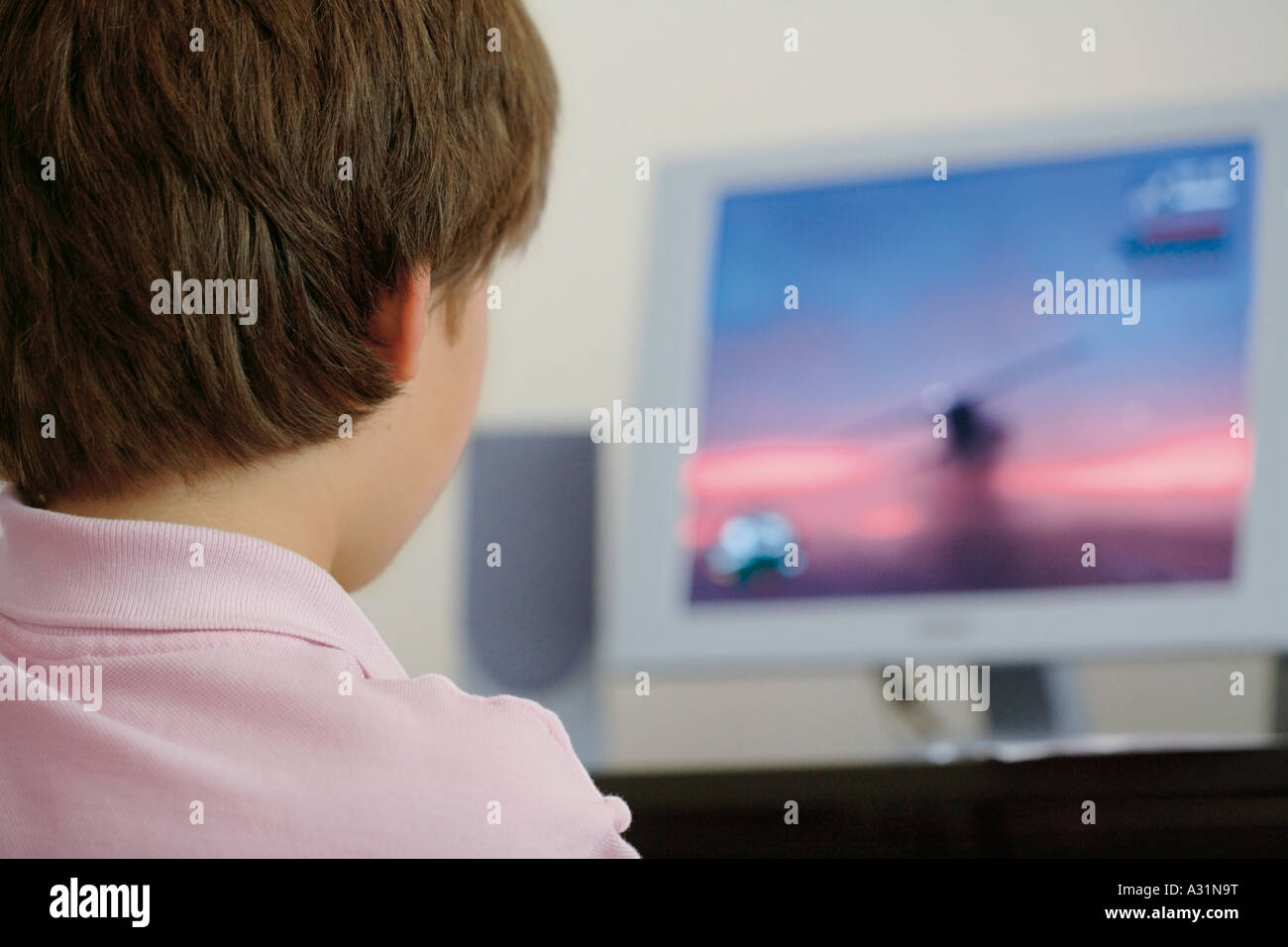 Boy playing games on desktop computer Stock Photo - Alamy