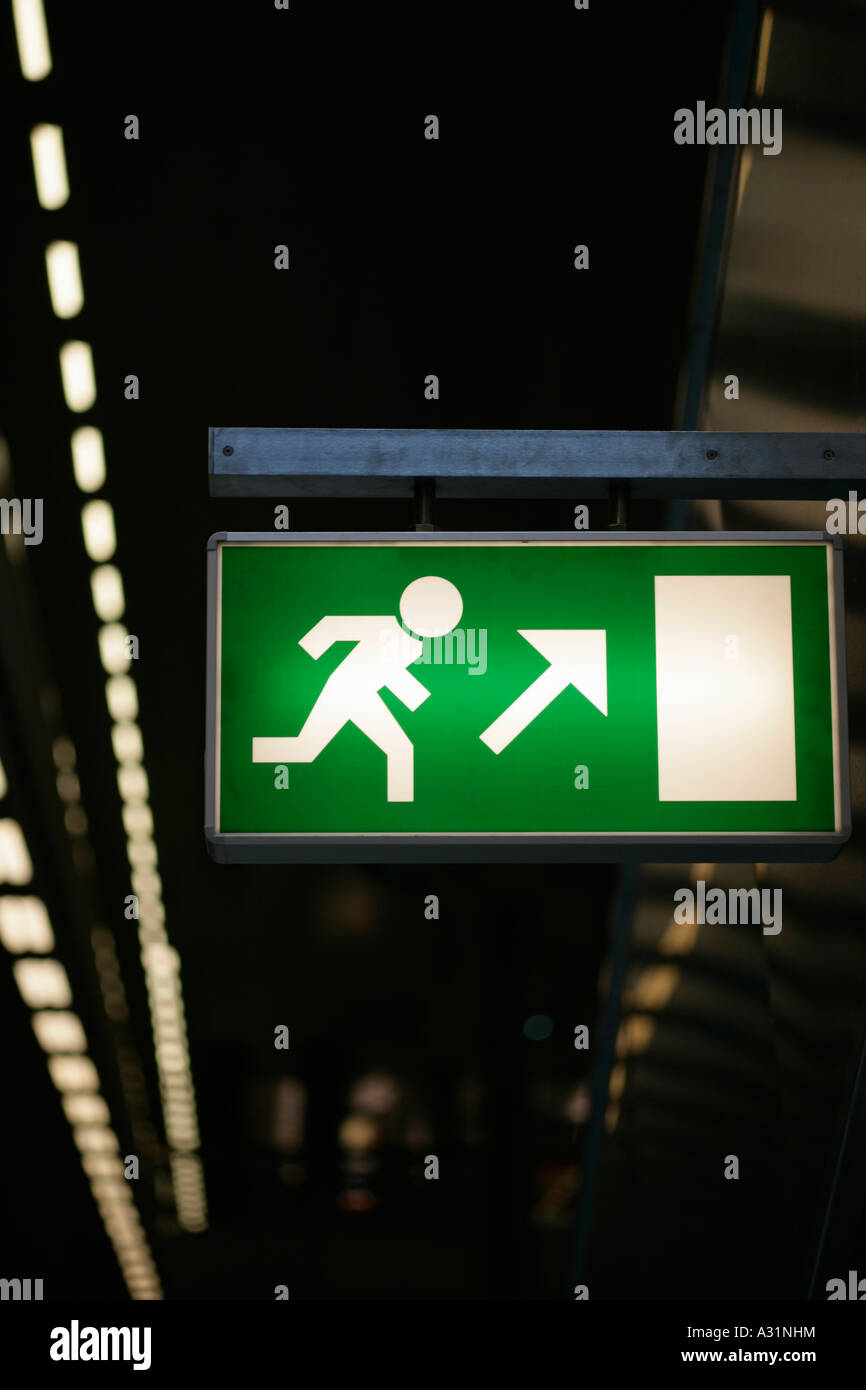 Illuminated emergency exit sign Stock Photo - Alamy