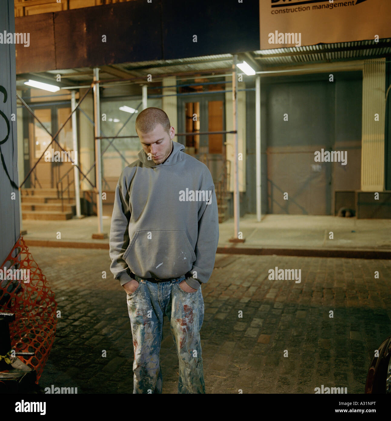 Young man standing in street at night Stock Photo - Alamy