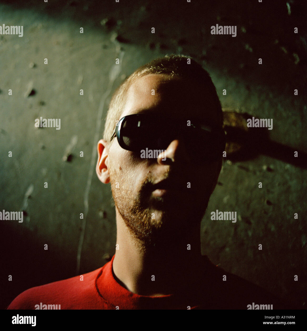 Young man wearing sunglasses in shadow Stock Photo - Alamy