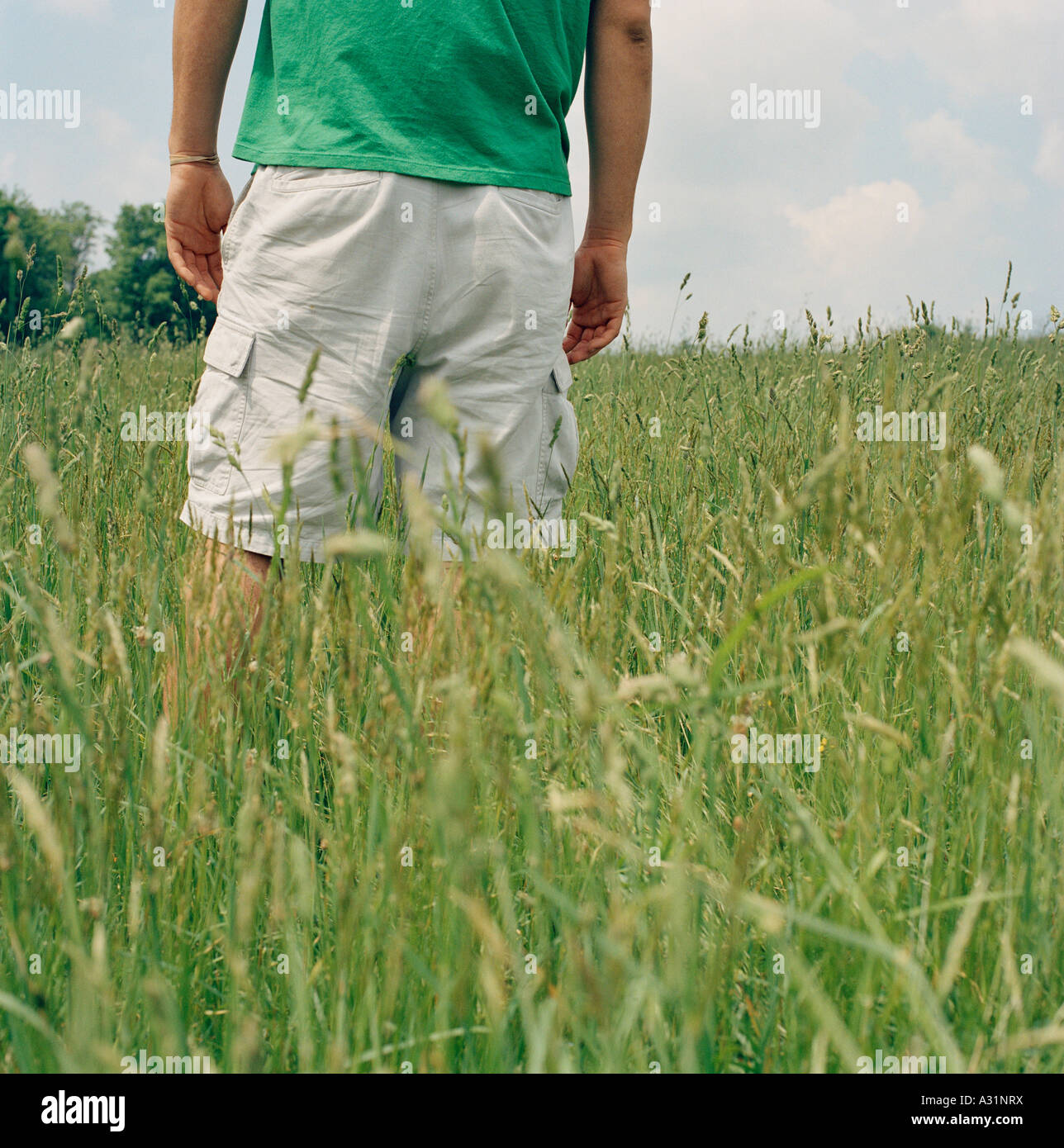 Man standing in field of grass Stock Photo - Alamy