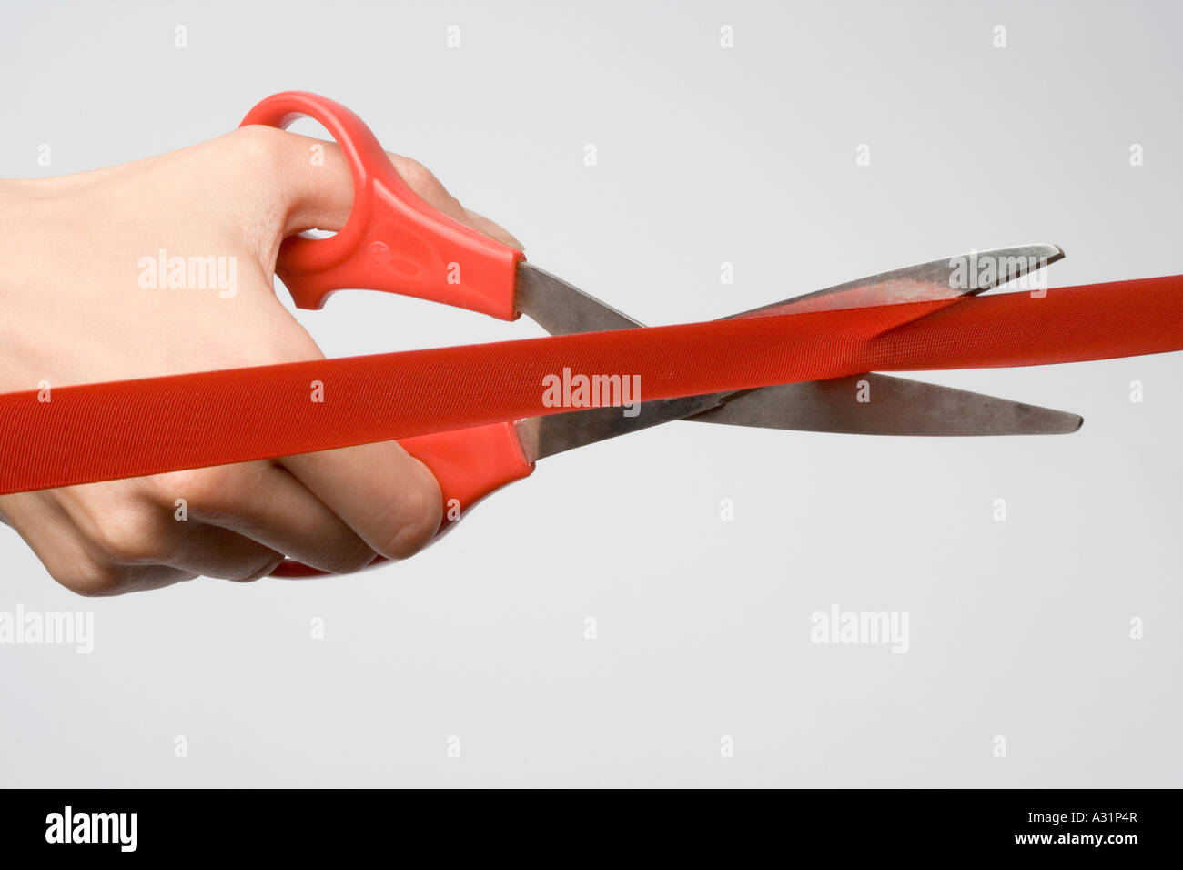 Person cutting red ribbon with scissors Stock Photo - Alamy