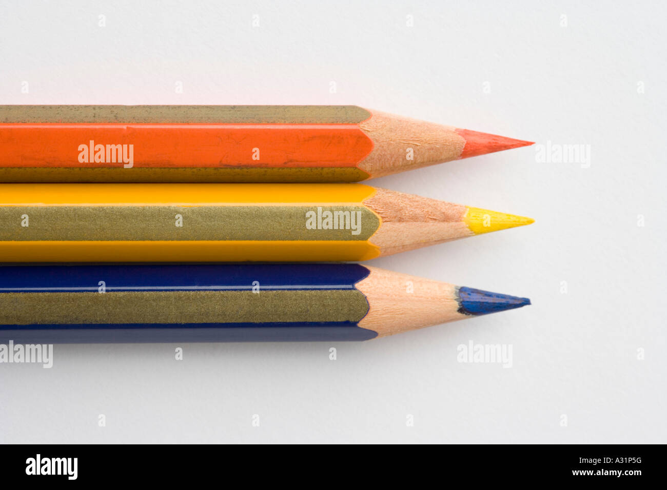 Three colored pencils in a row Stock Photo - Alamy