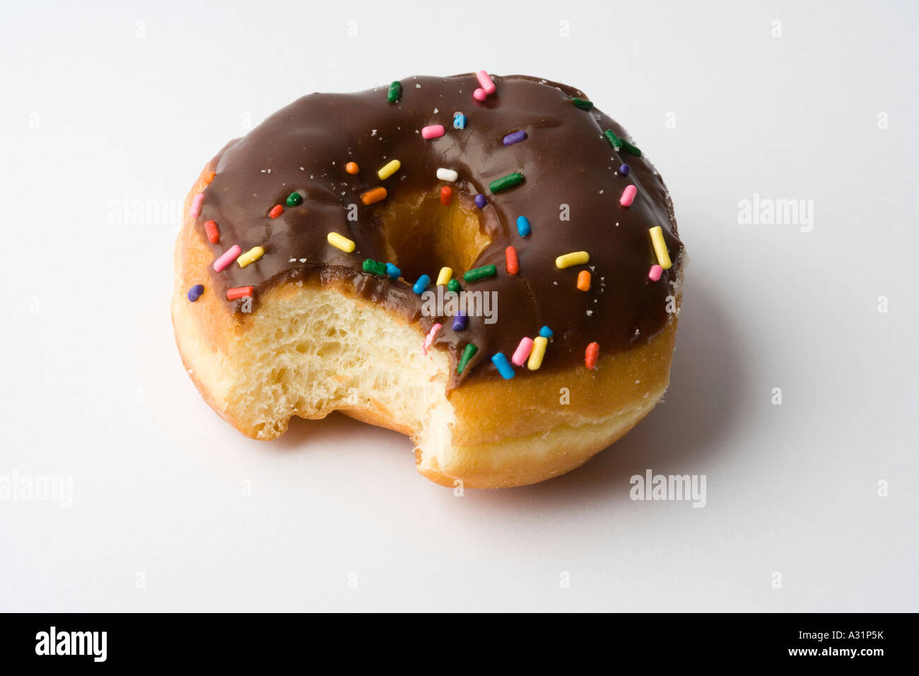 Chocolate ring donut with missing bite Stock Photo - Alamy