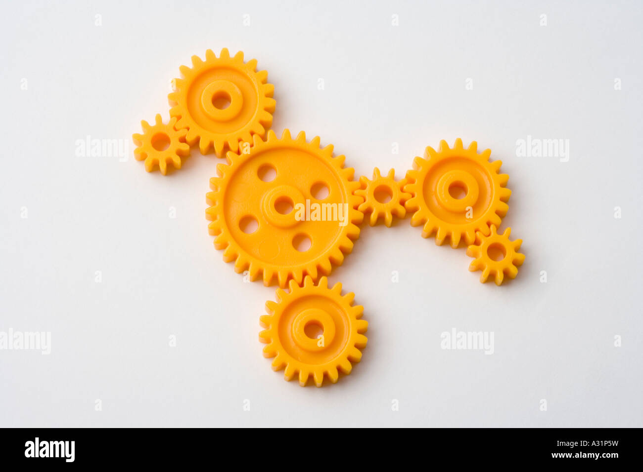 Seven orange cogs interlocked Stock Photo - Alamy
