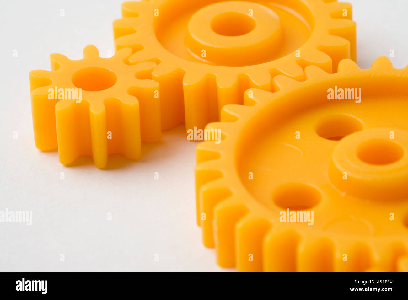 Three cogs interlocked Stock Photo - Alamy