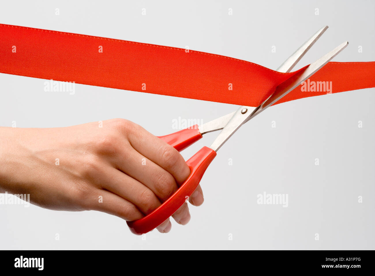 Person cutting red ribbon with scissors Stock Photo - Alamy