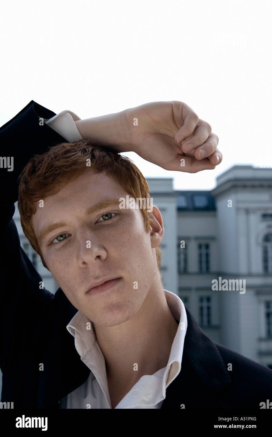 Young man resting arm on head Stock Photo - Alamy