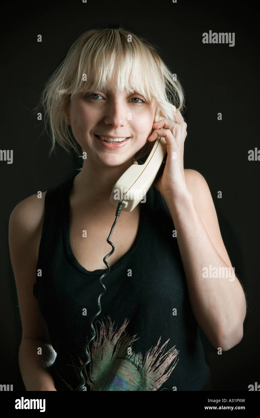 Young woman using landline telephone Stock Photo - Alamy