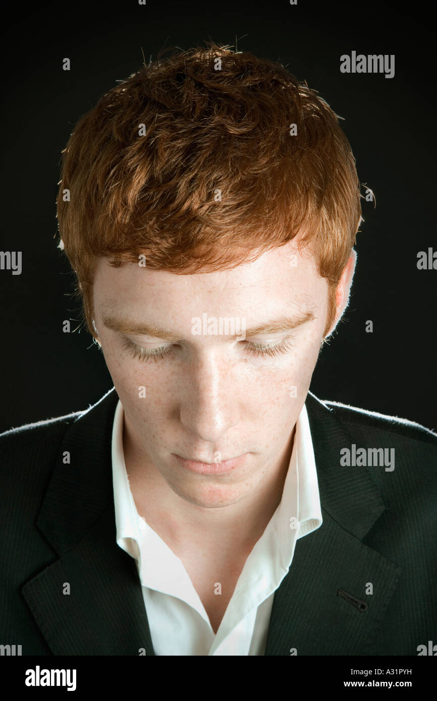 Young man with head down Stock Photo - Alamy