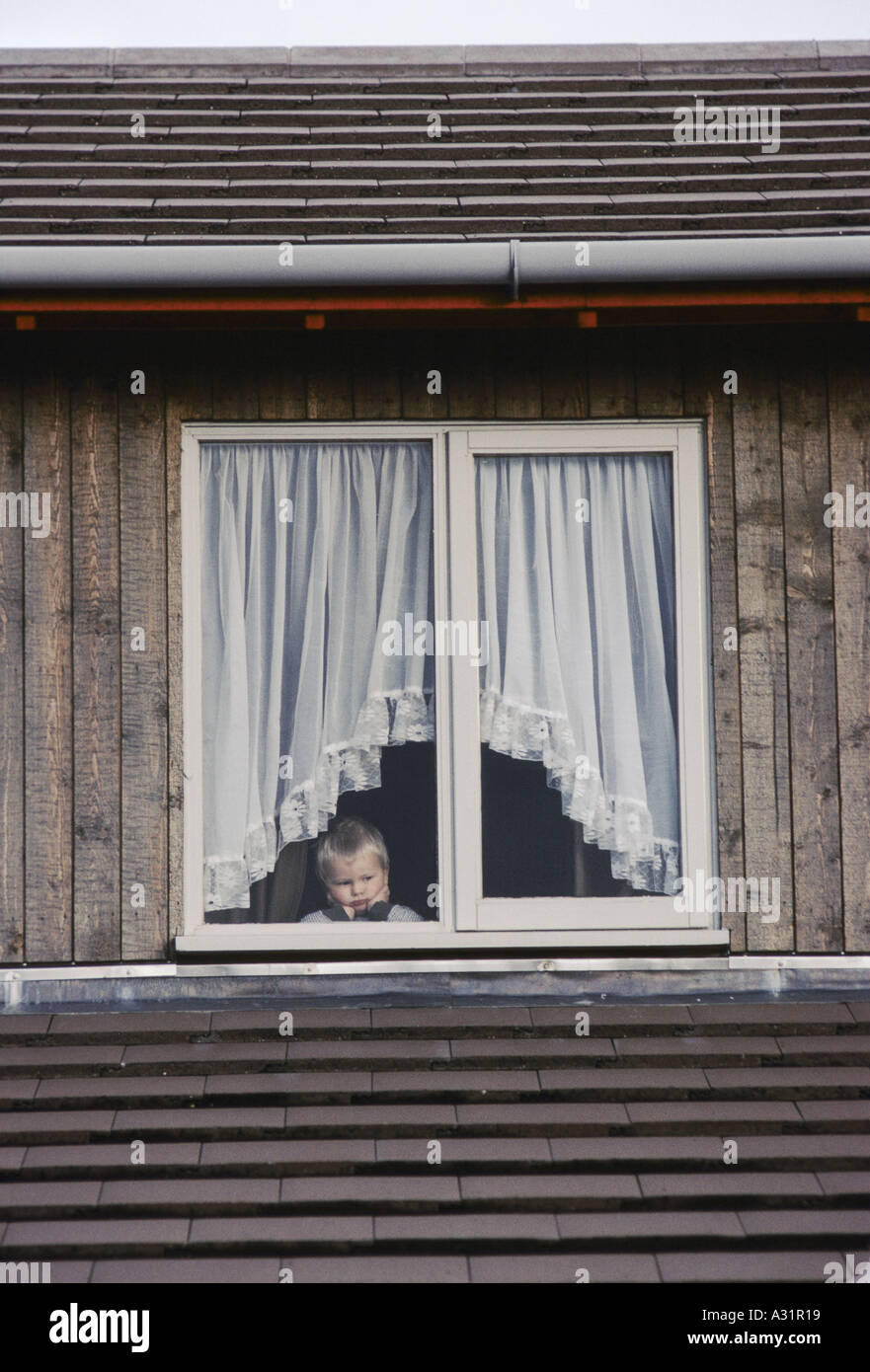 child looking at the window his two little hands holding his head Stock ...