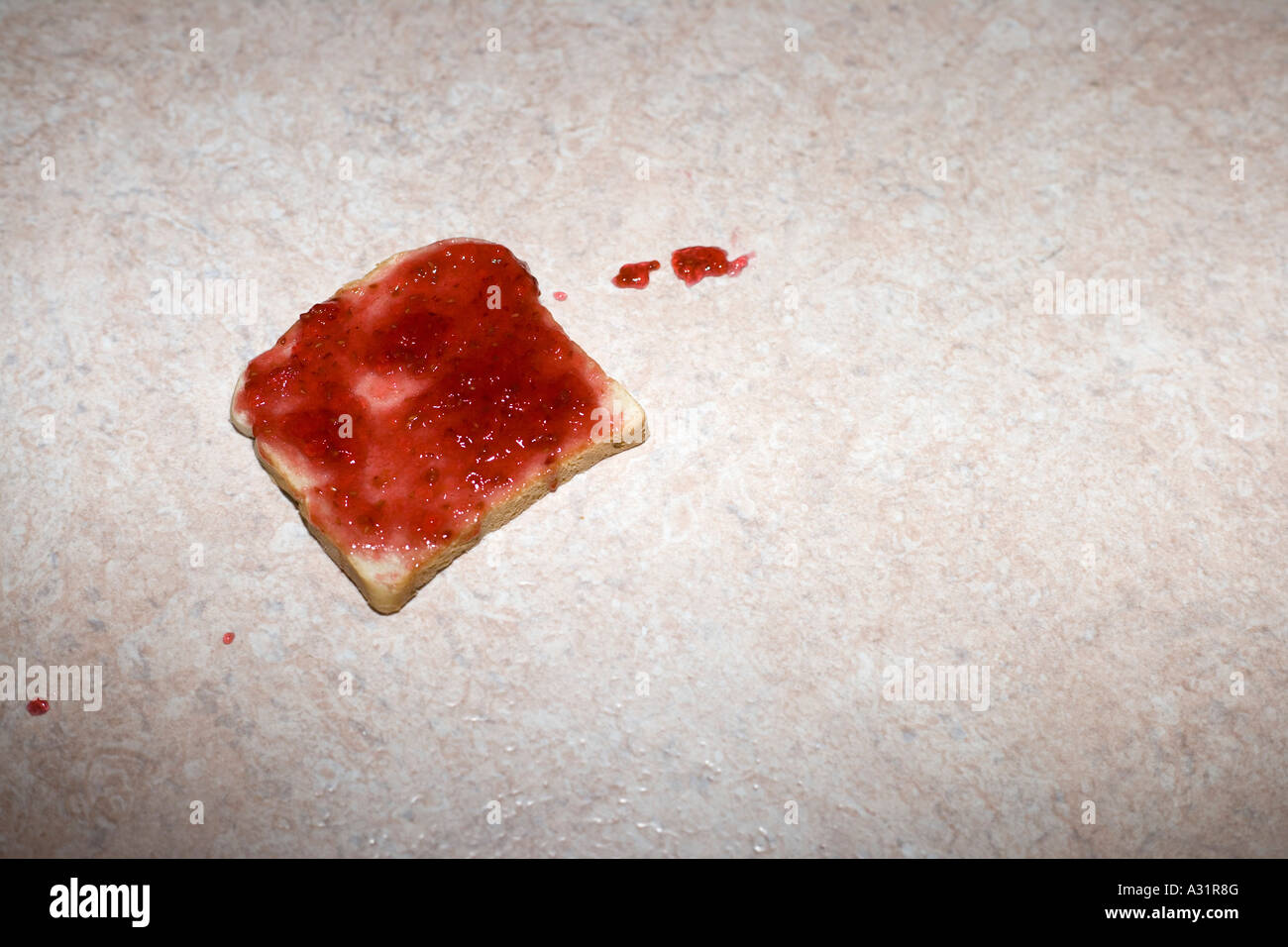 Slice of toast with strawberry jam dropped on the floor Stock Photo - Alamy