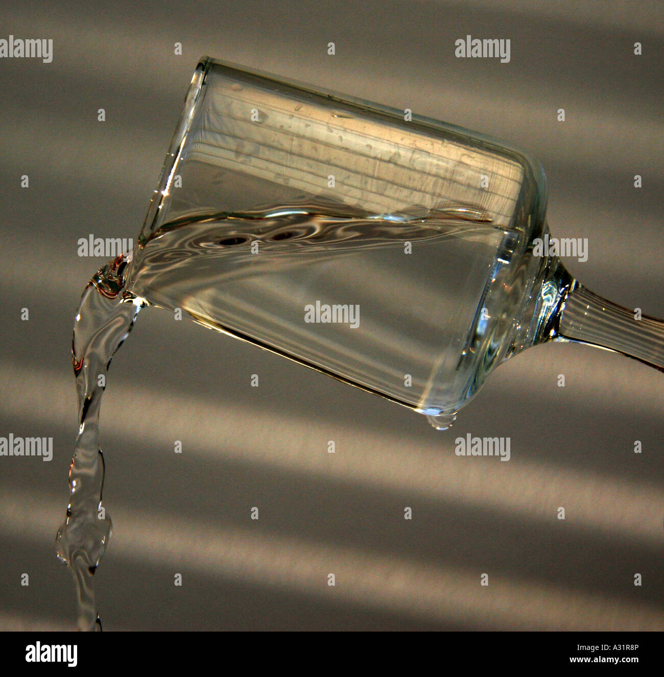 Water pouring from a glass Stock Photo - Alamy