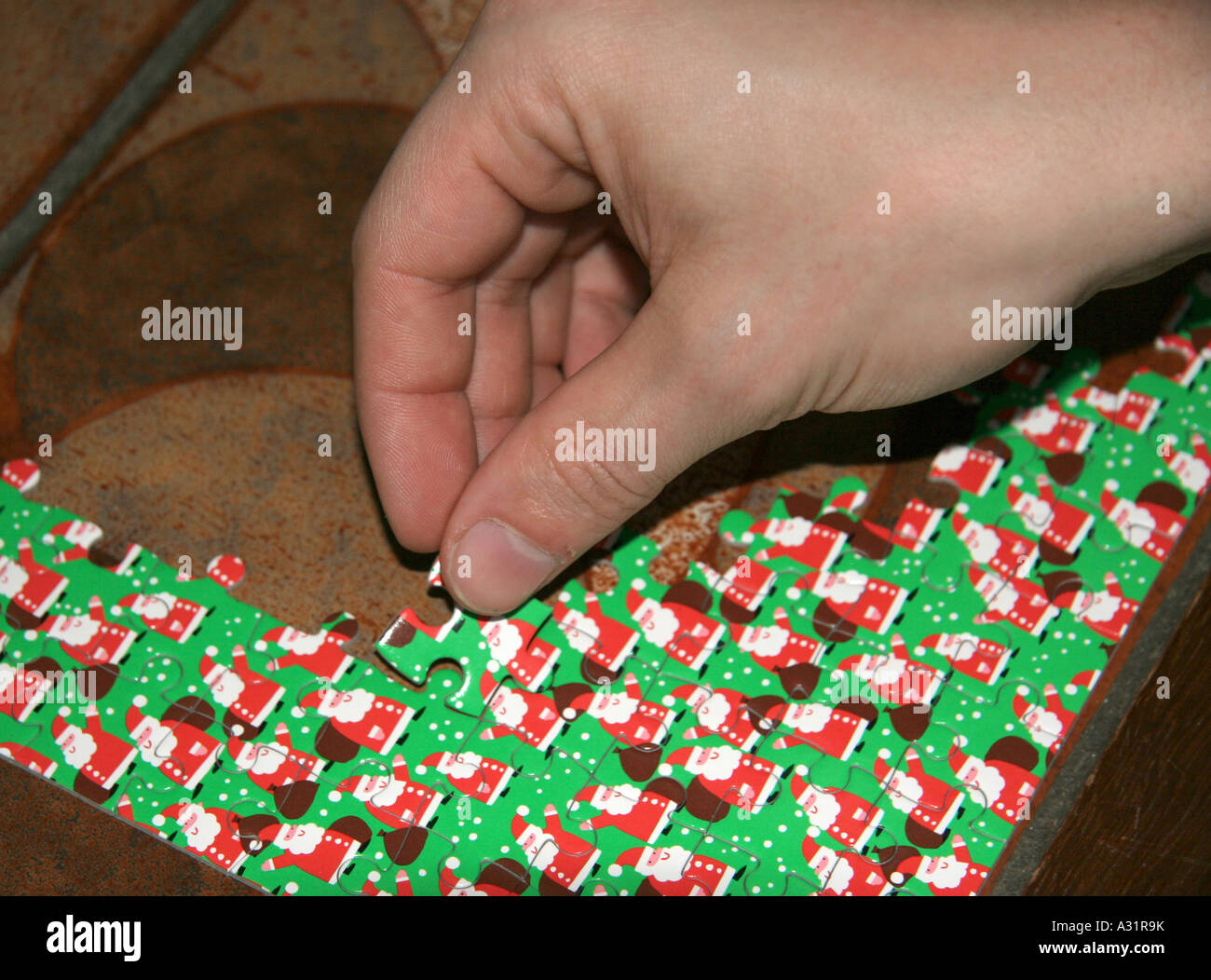 A hand doing a Jigsaw puzzle Stock Photo - Alamy