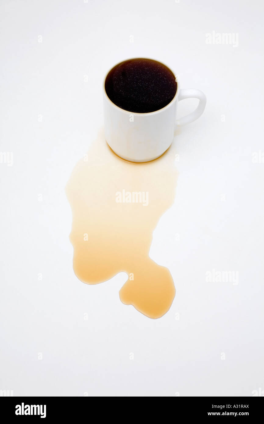 Cup of coffee overflowing Stock Photo - Alamy