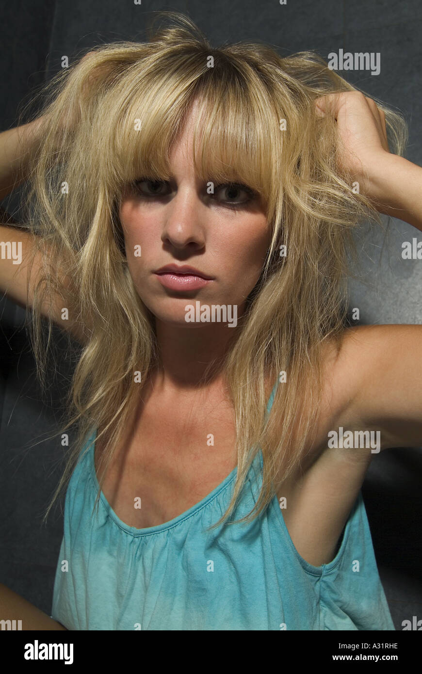 Young woman with hand in hair Stock Photo - Alamy