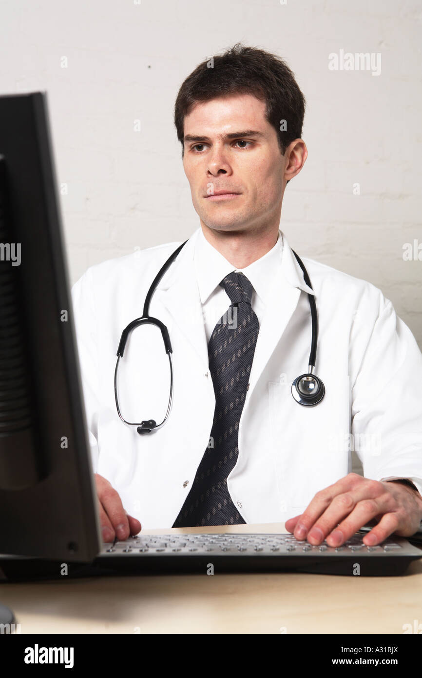 Doctor behind a desk Stock Photo - Alamy