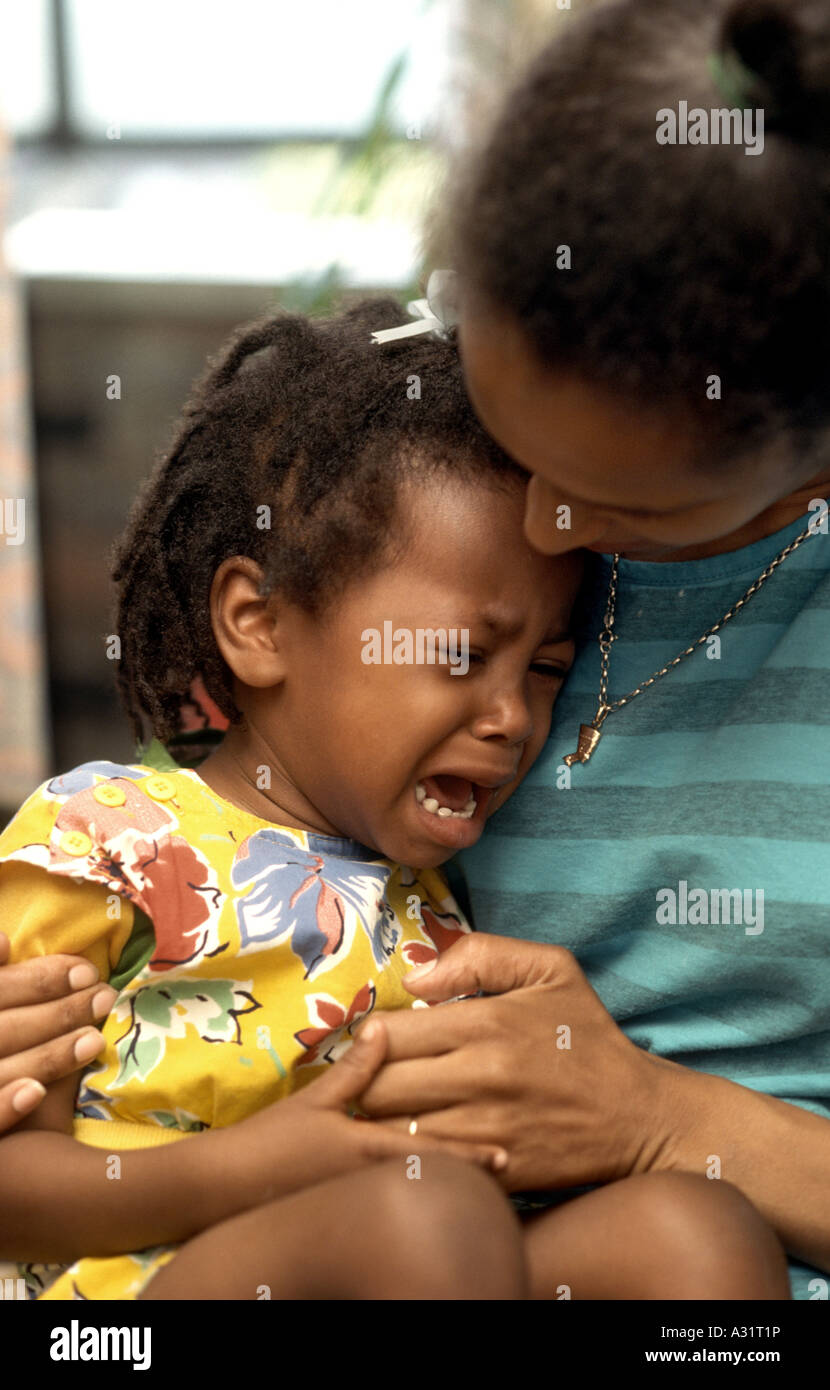 mother consoling crying child Stock Photo - Alamy