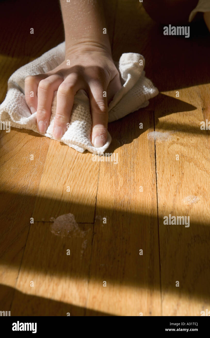 Hand cleaning wooden floor Stock Photo - Alamy