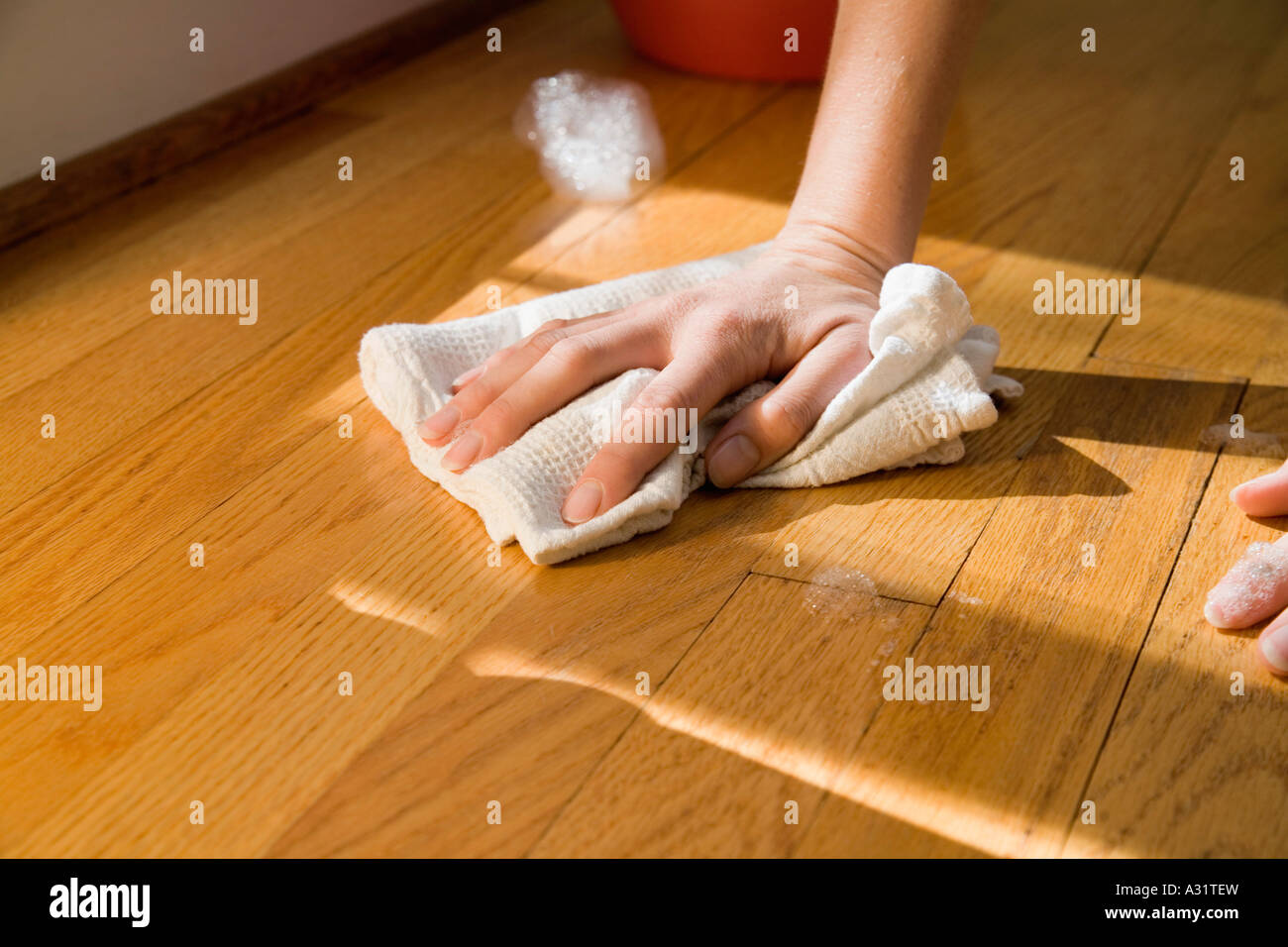 Hand clean wooden floor with rag Stock Photo - Alamy