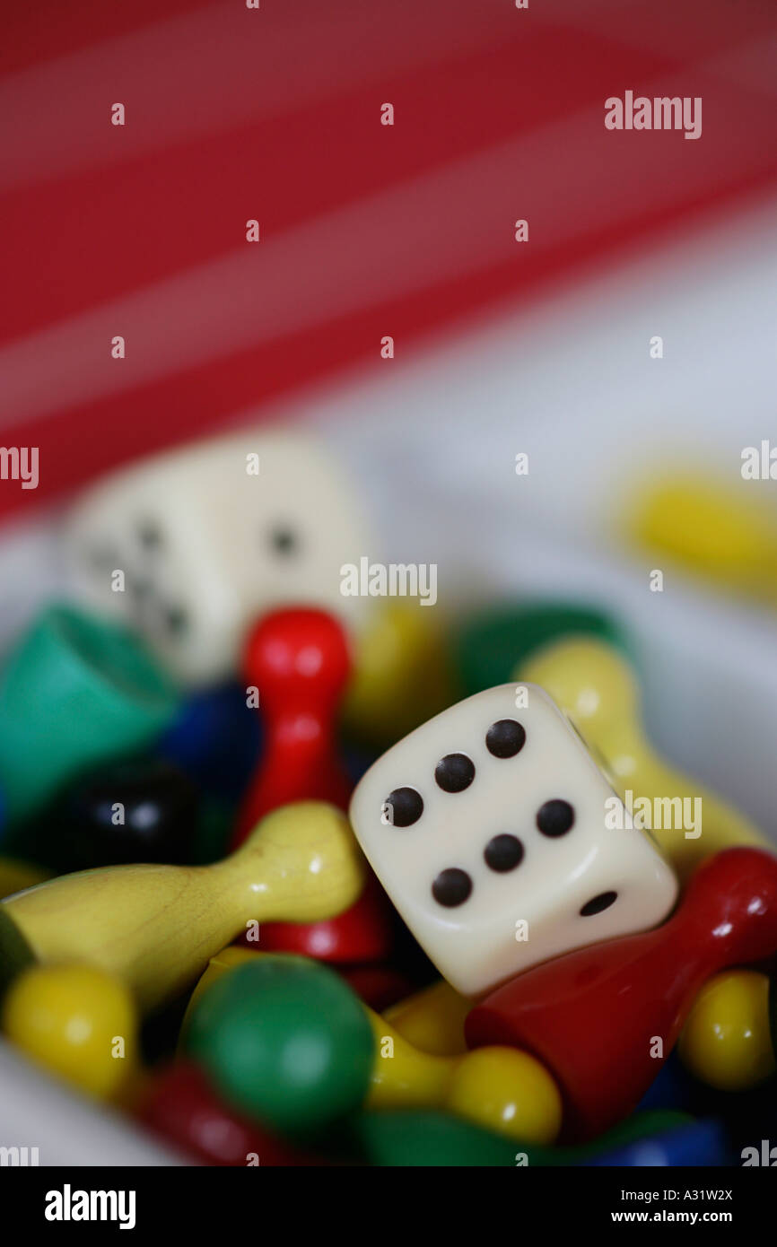 Heap of game pieces and dice Stock Photo - Alamy