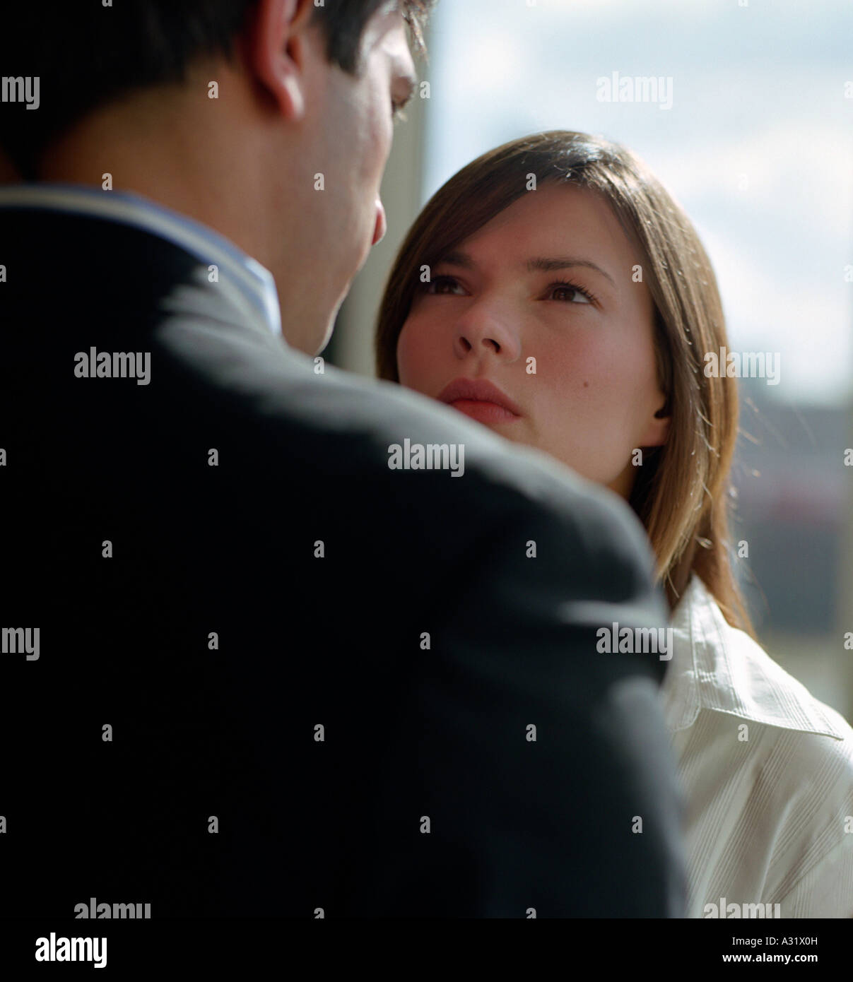 Woman and man standing face to face Stock Photo - Alamy