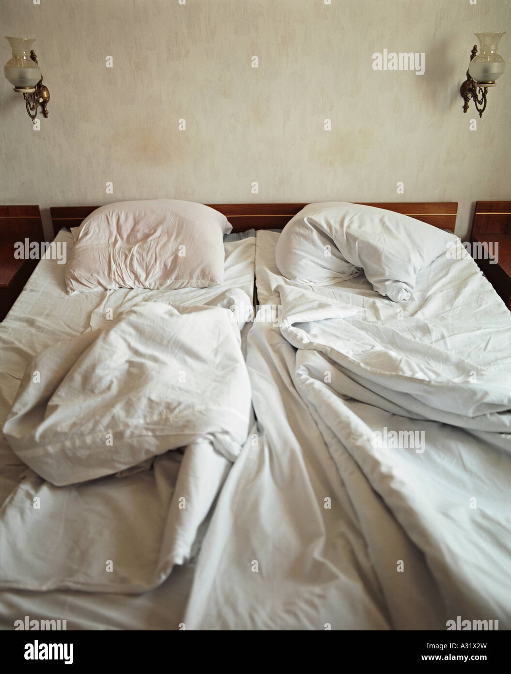 Unmade bed in hotel room Stock Photo - Alamy