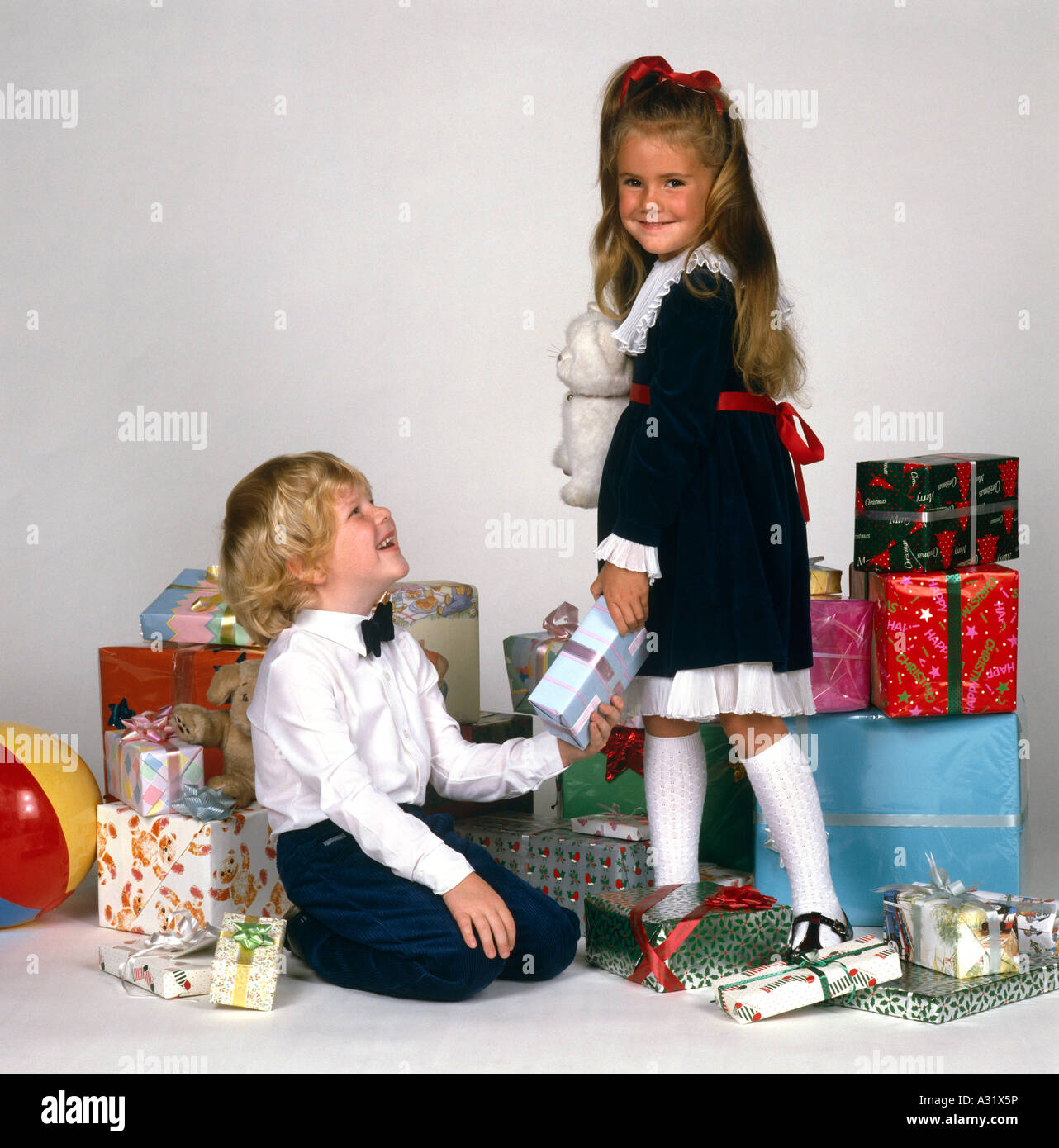 Young children exchanging gifts Stock Photo - Alamy