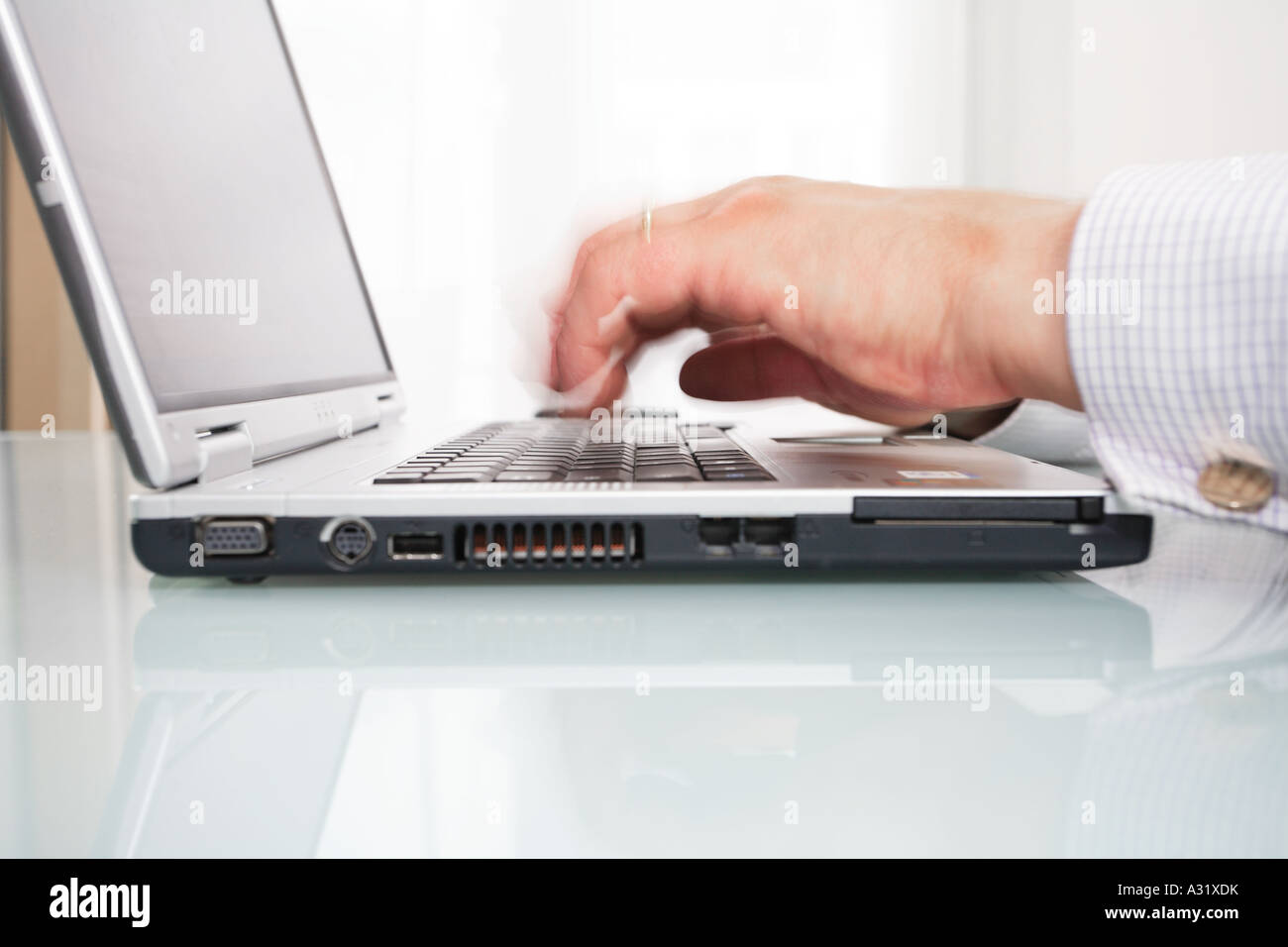 Typing on a laptop Stock Photo - Alamy